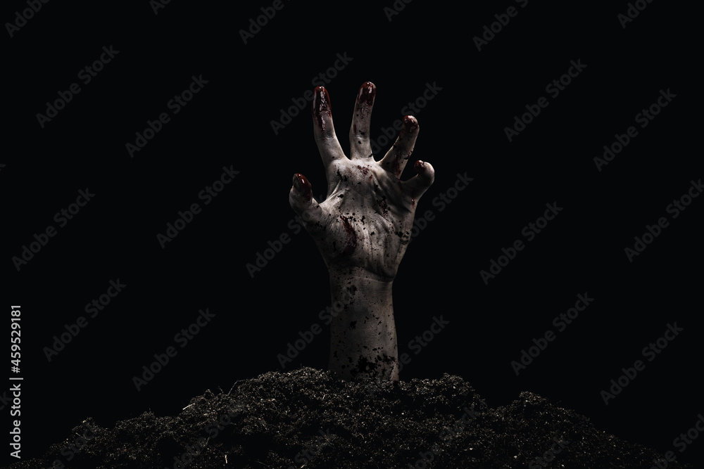 Creepy bloody and dirty hand rising from the ground. Black background ...