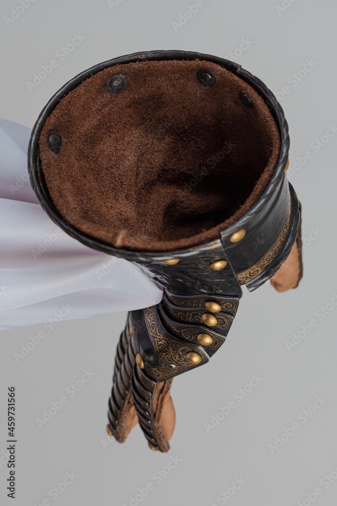 Medieval knightly brown plate gauntlet from Italian armor, in the form ...