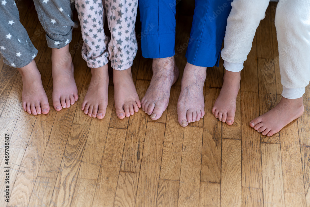 Several pairs of bare feet of people of different ages. Children and ...