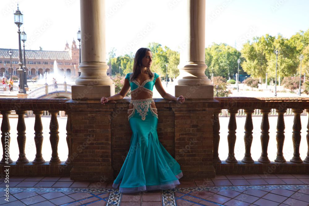 beautiful young belly dancer is posing for the camera in a photo shoot ...