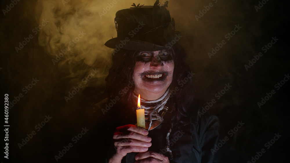 Creepy mature woman grandmother with Halloween stylish witch makeup ...