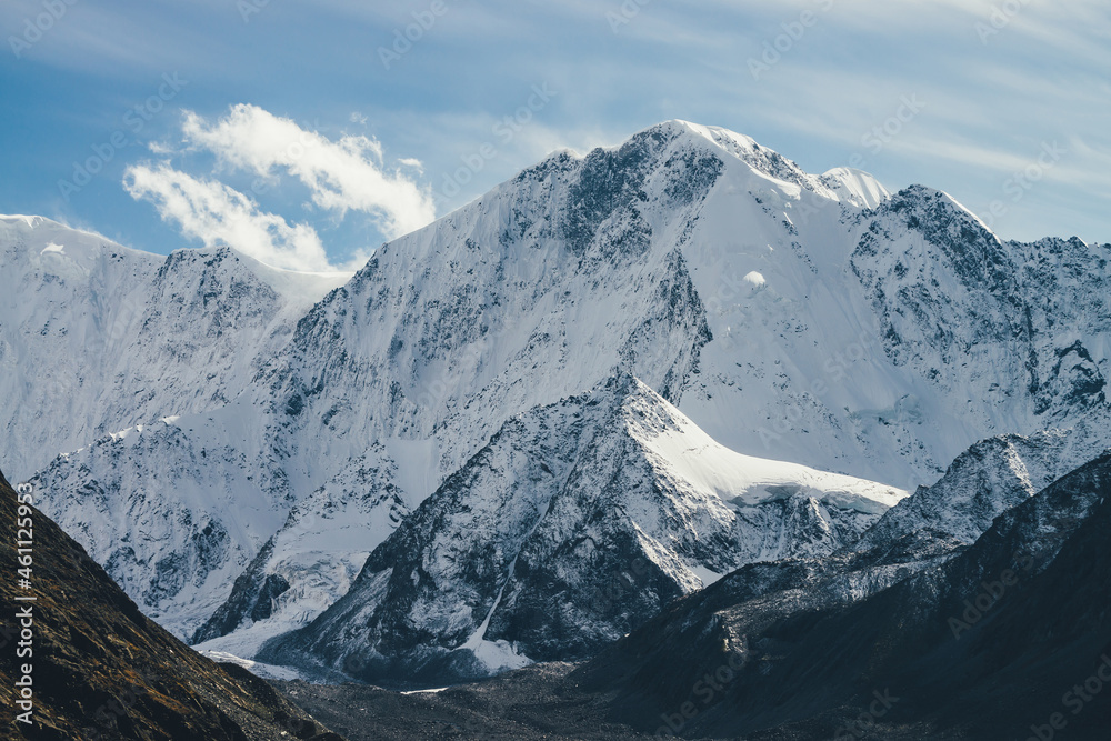Alpine sunny landscape with high snowy mountain with peaked top and ...