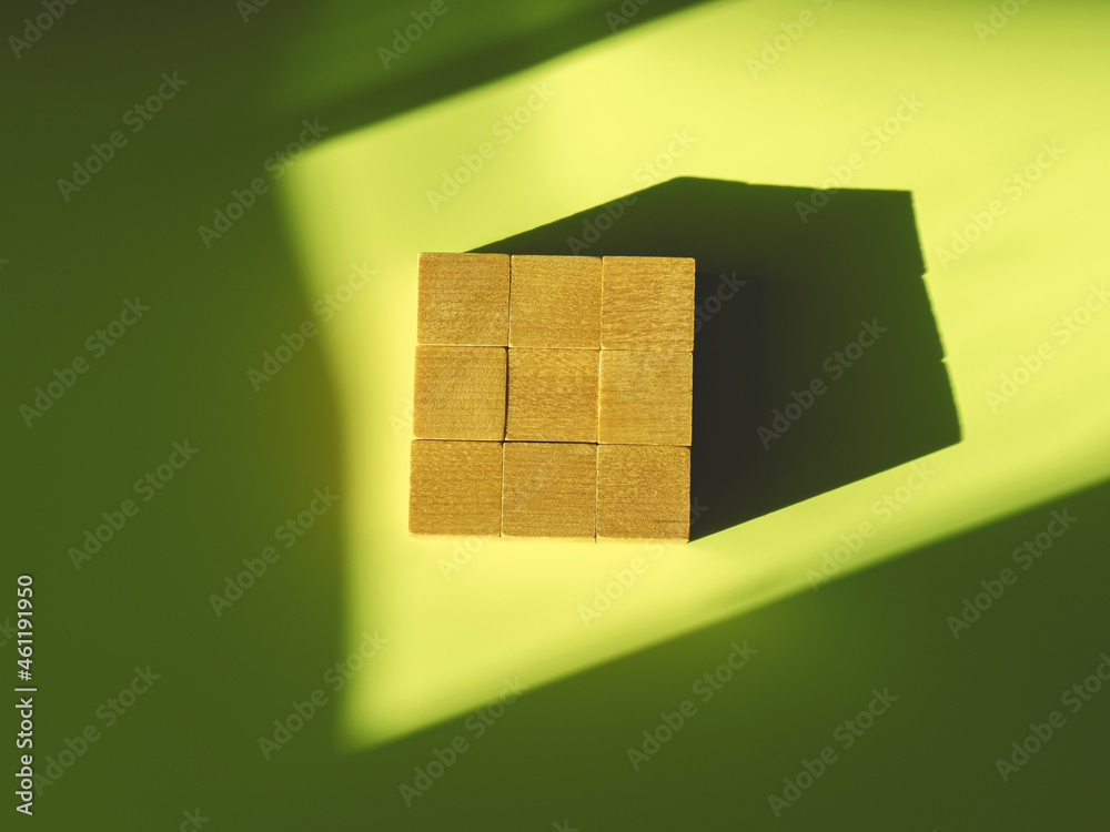 Nine wooden blocks in the form of the square on the green background ...