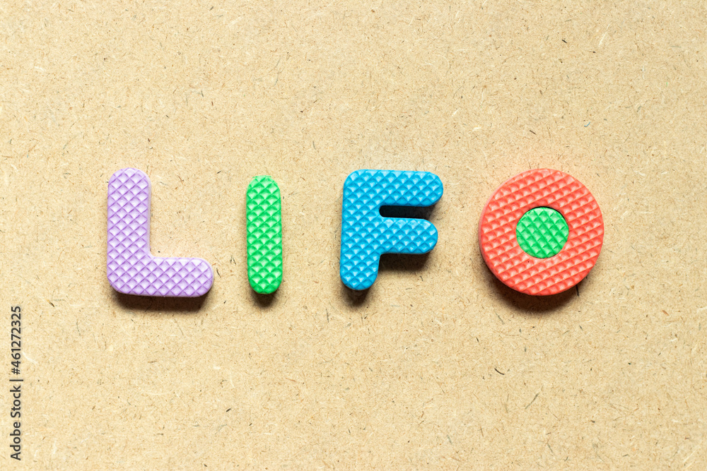 Foam alphabet letter in word LIFO (abbreviation of last in first out) on wood background Stock ...