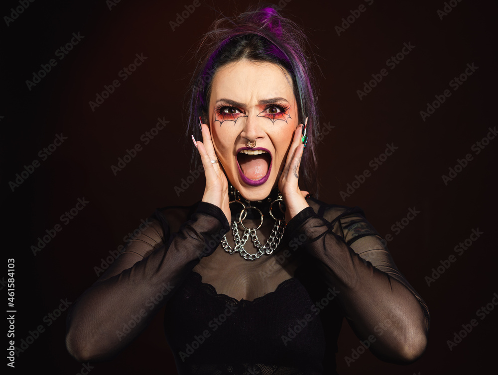 Purple hair goth woman screaming, halloween makeup and crazy expression ...
