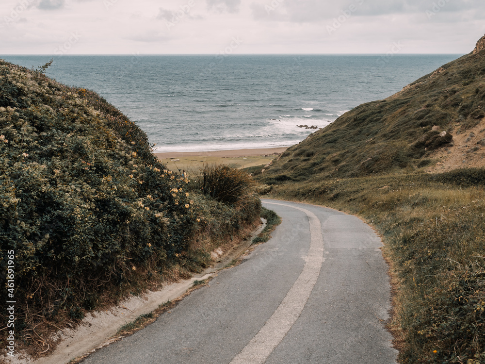 I walk between lonely beaches in Bizkaia. Huge natural beach surrounded ...