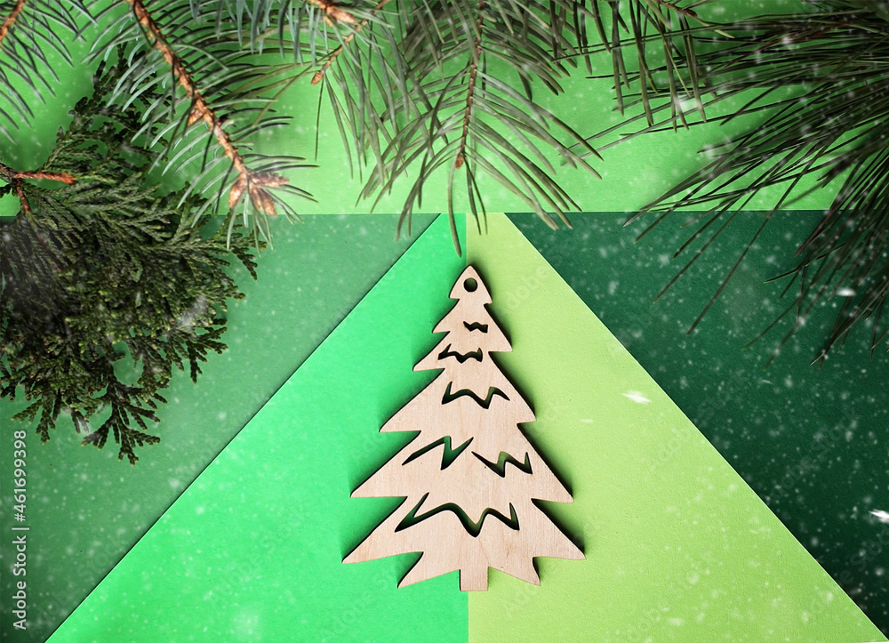 Simple wooden tree lays on the green color gradation paper background ...