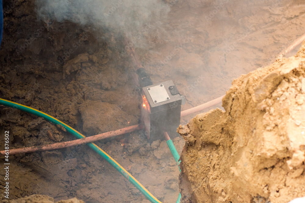 Welding copper ground wire on ground rod.Welding copper ground wire ...