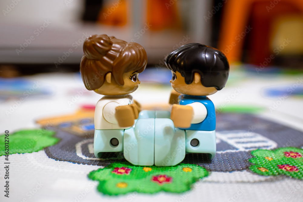 LEGO people sit opposite each other. Two toy persons sit opposite each ...