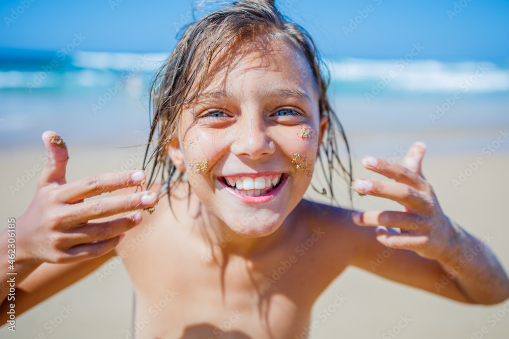 Young boy posing at the summer beach. Cute spectacled smiling happy 12 ...