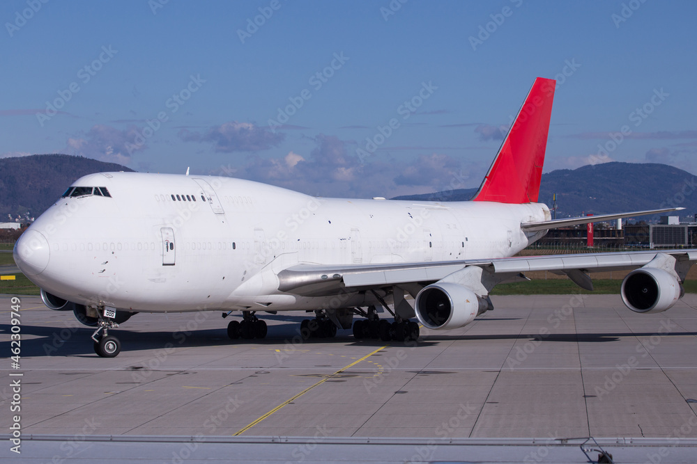 Huge Boeing 747-400 Jumbo Jet freighter with red tail on the ground ...