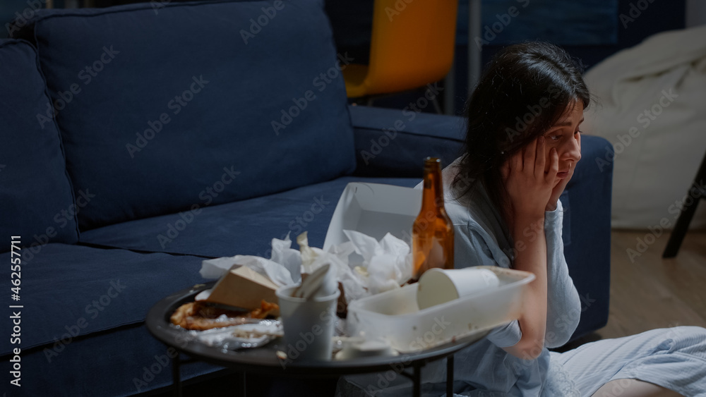 Sad depressed woman sitting on floor swaying desperately putting hands ...