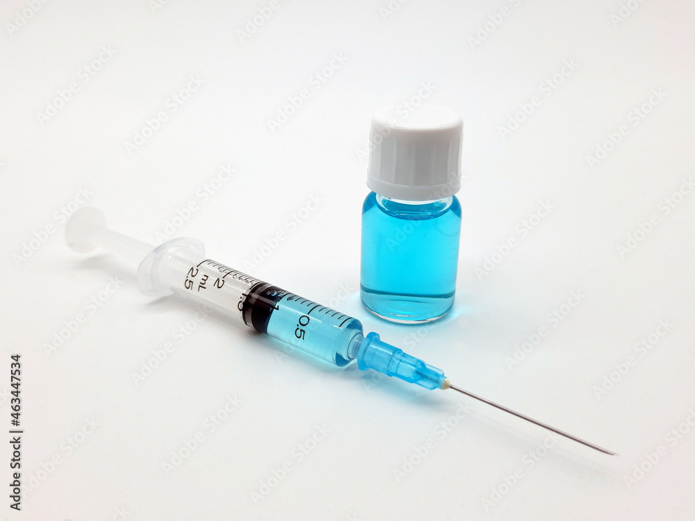 A syringe and a vial filled with a covid-19 vaccine for innoculation of ...