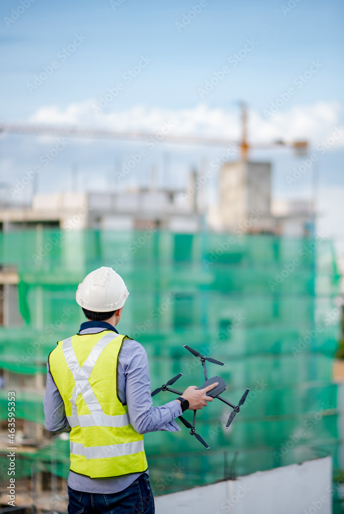 Asian engineer man holding drone at construction site. Male worker ...