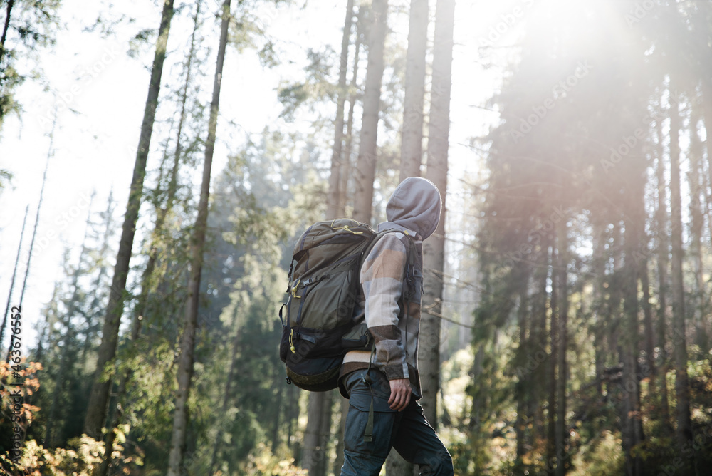 Back view of male hiker backpacker in highlands mountains. Man with ...