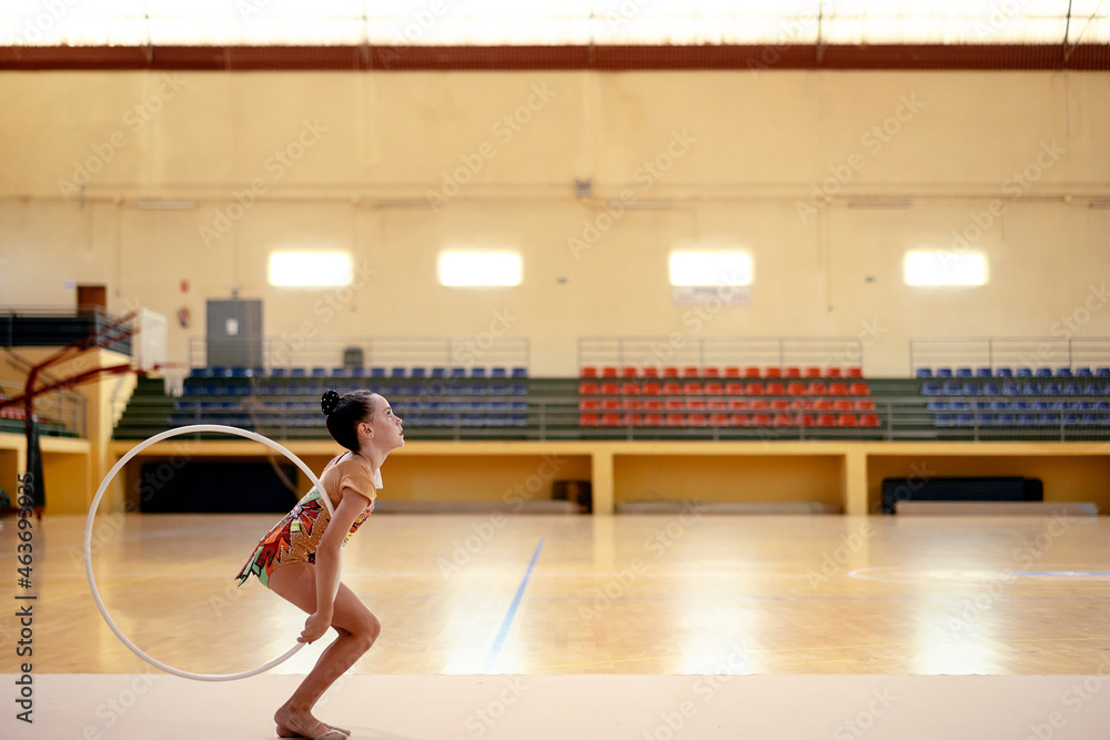 Gymnastics girl taking impulse to throw the hoop up Stock Photo | Adobe ...