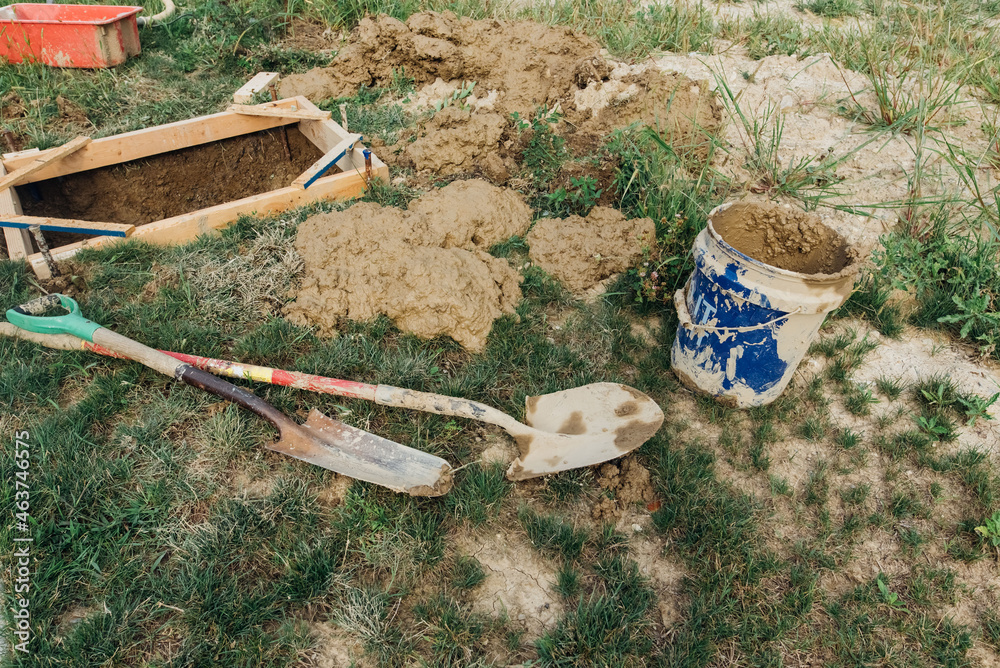 Dirty tools laying on the ground. Stock Photo | Adobe Stock
