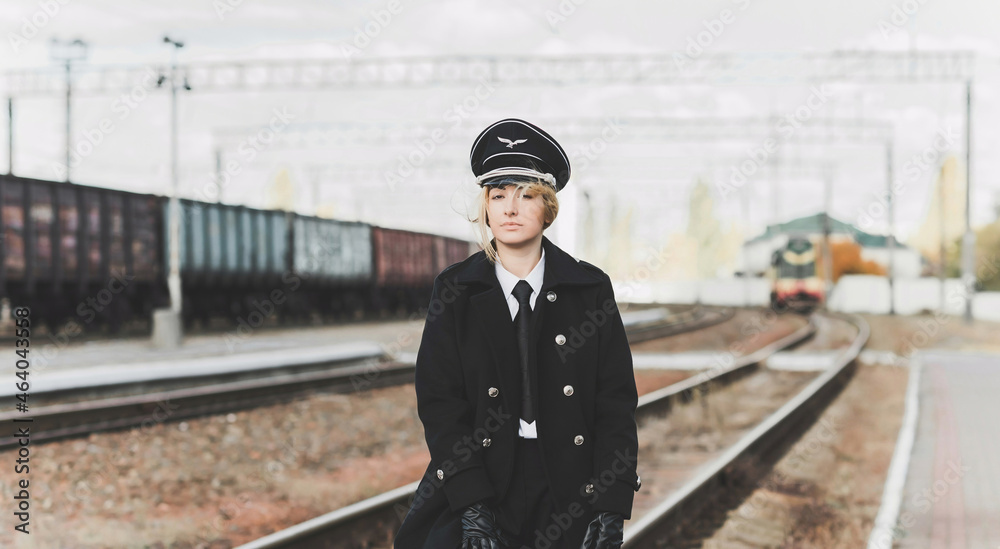 European or American train conductor is on his duty on a platform and ...