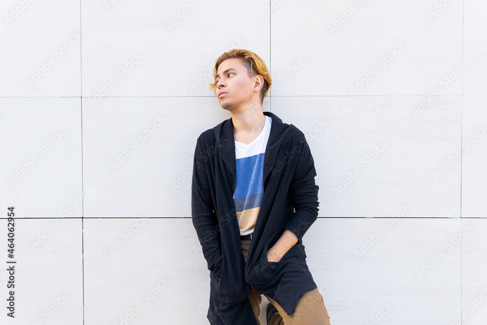 Stylish man standing near wall Stock Photo | Adobe Stock