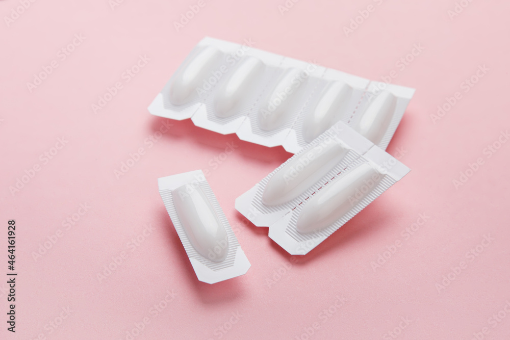 vaginal suppositories on pink background, treatment of vaginal infections from candidiasis ...