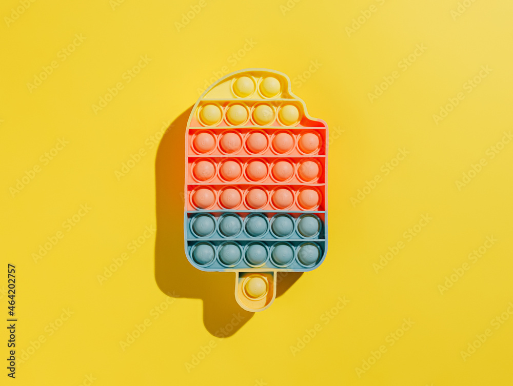 Pop it fidget toy with pokable bubbles in shape of popsicle on vibrant ...
