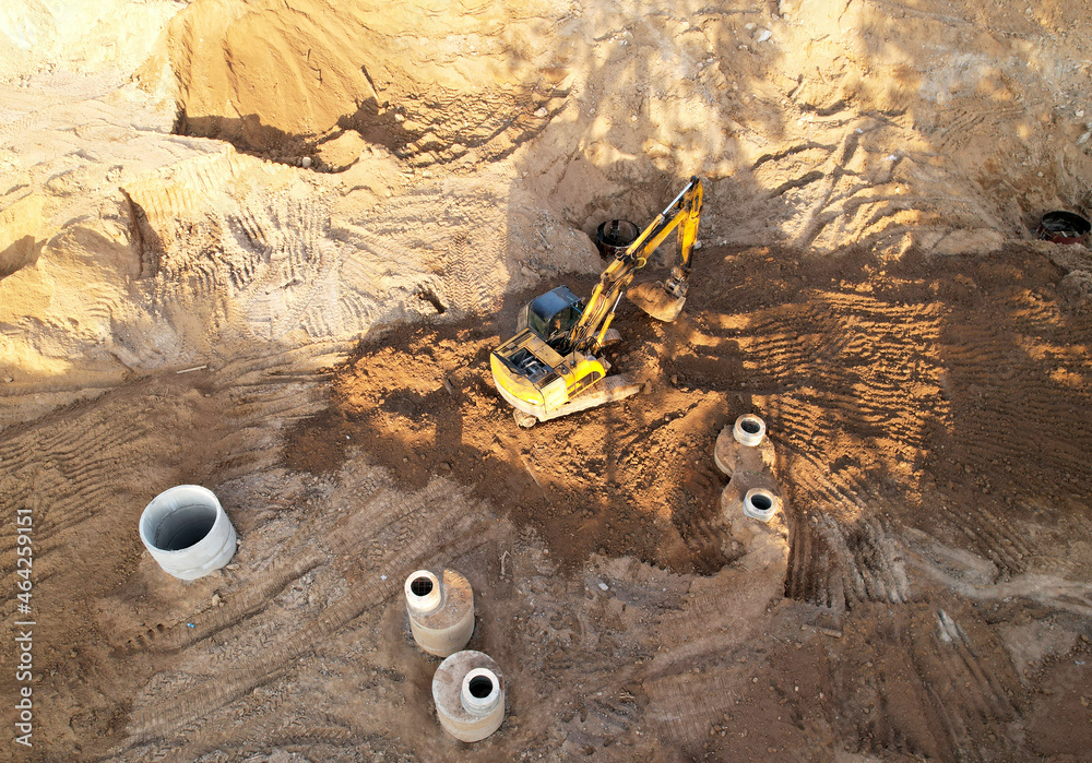 Excavator dig ground for sewerge construction. Trench for laying a ...