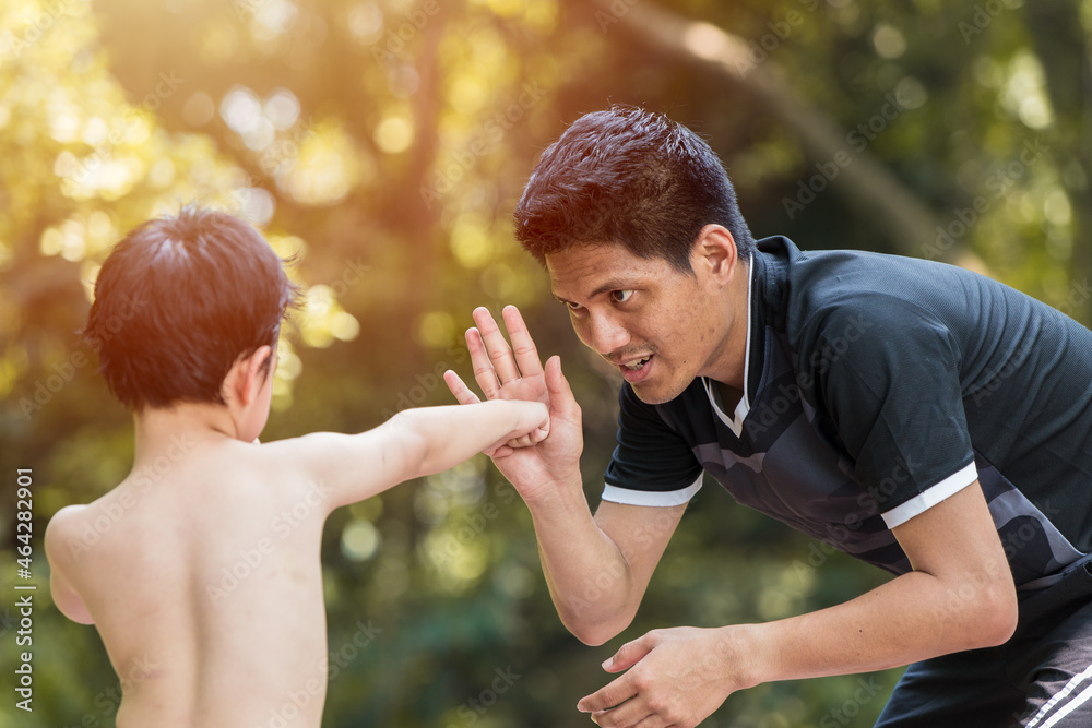 kid boxing. young boy boxer practice muay Thai punches with father ...