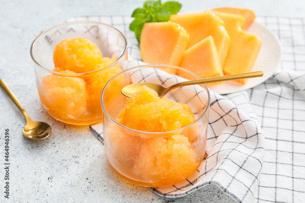 Bowls with delicious melon sorbet on light background Stock Photo ...