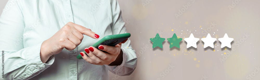 Excellent. Person using mobile phone with icon two star symbol to ...