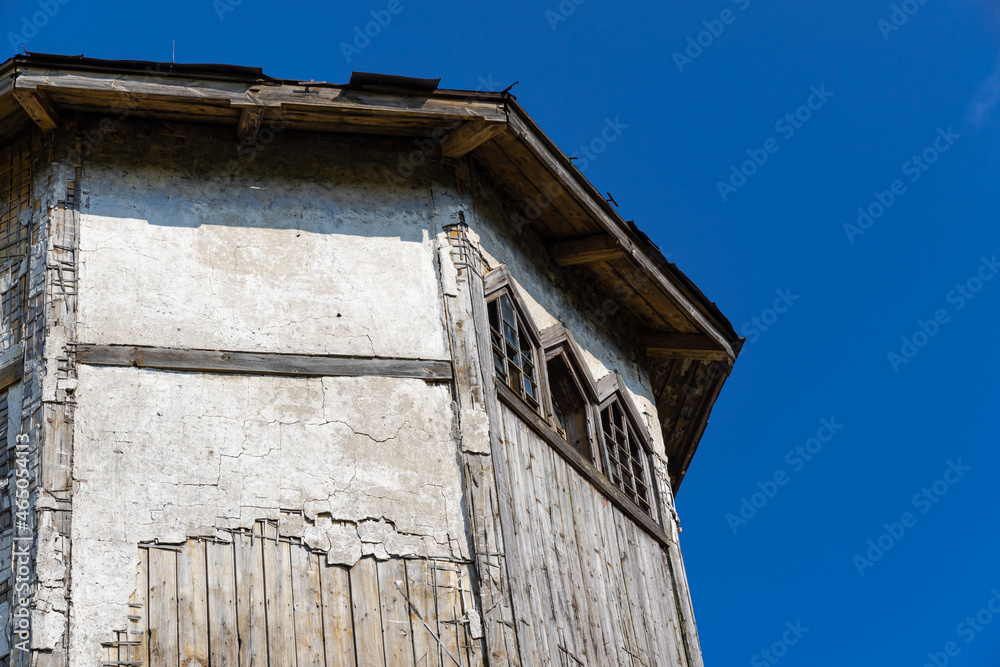 The upper part of an ancient watchtower made of stone blocks and wood ...