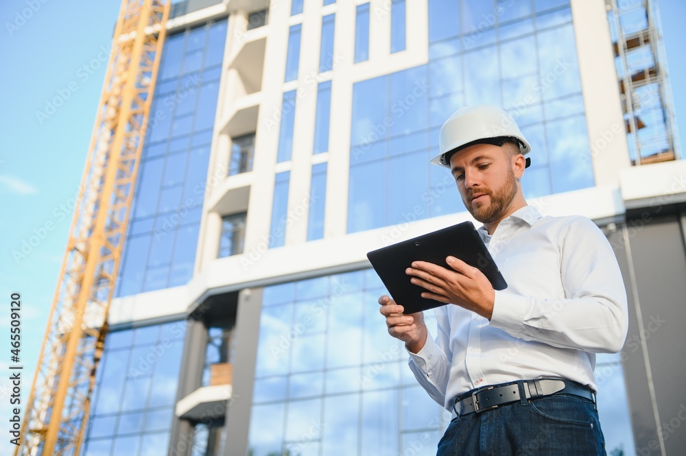 Engineer next to building cranes. Concept - large construction project ...