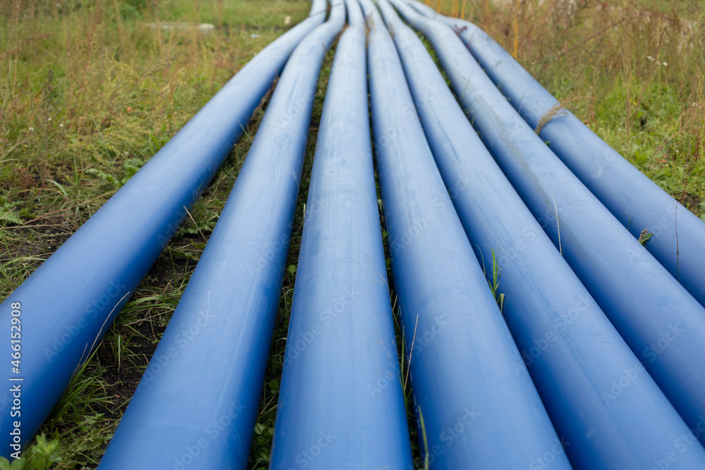 Blue plastic pipes. Flexible pipes for sewerage. Laying of heating ...