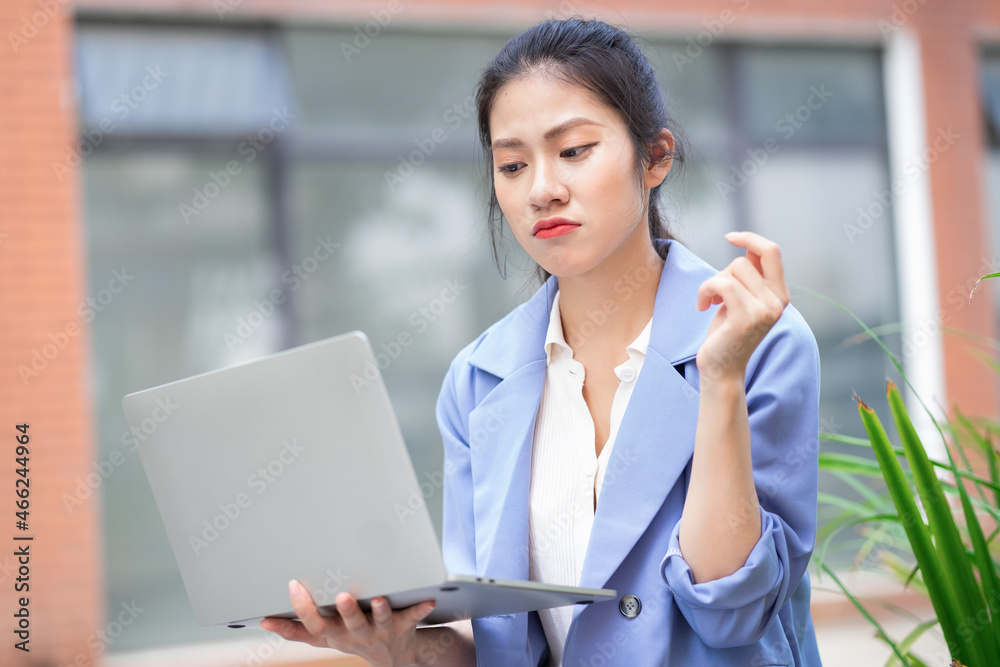 Young Asian woman working outside Stock Photo | Adobe Stock