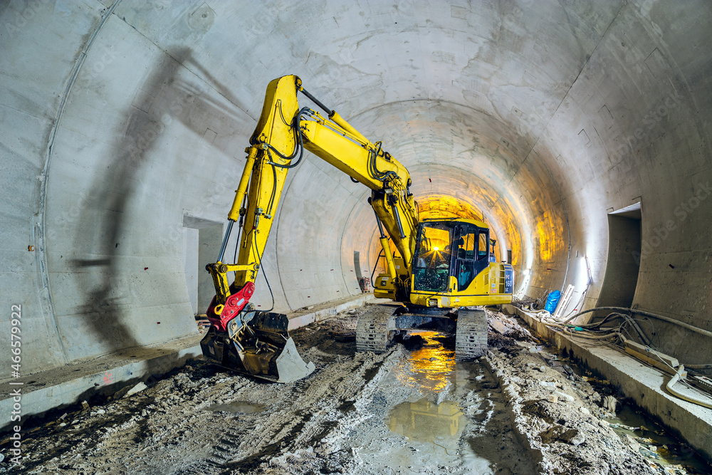 Excavator in construction place of building new railway tunnel. Railway ...