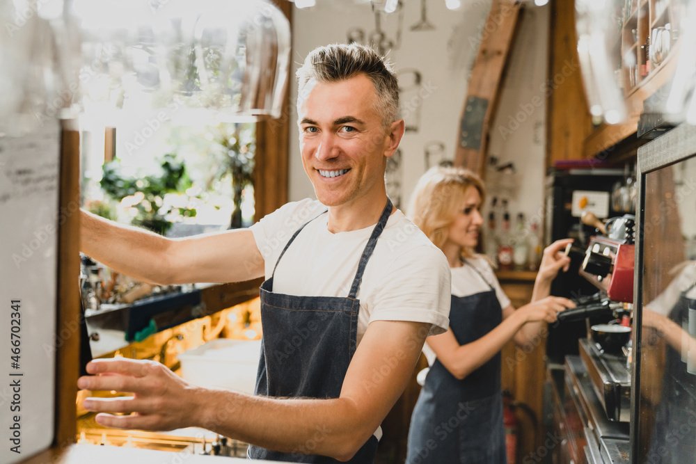 Confident smiling middle-aged small business owners barista bartenders ...