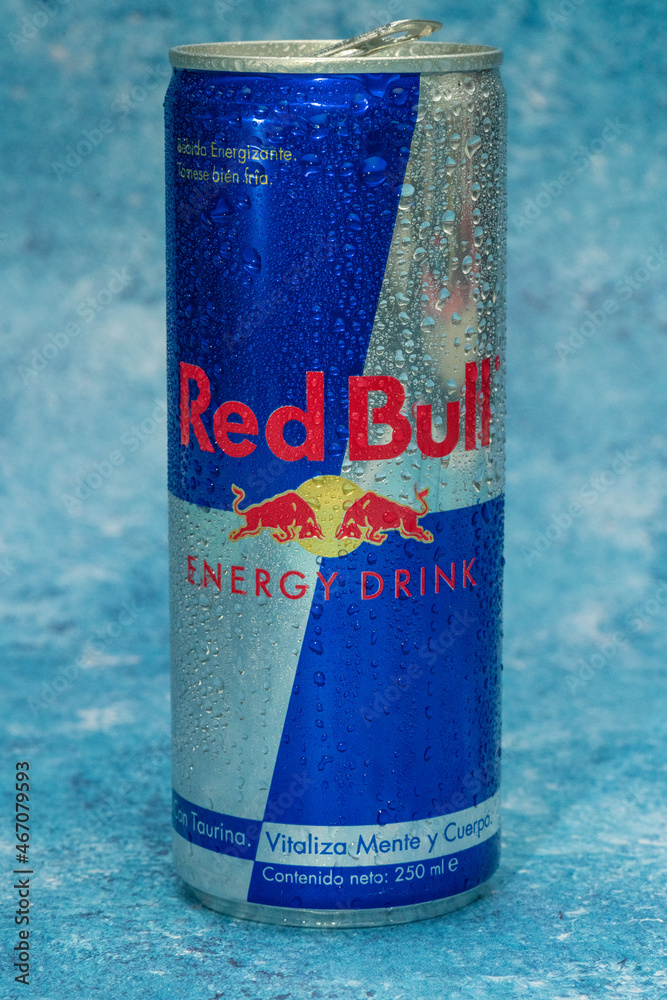 Aluminium can of Red Bull Energy drink with ice and drops. Red Bull is ...