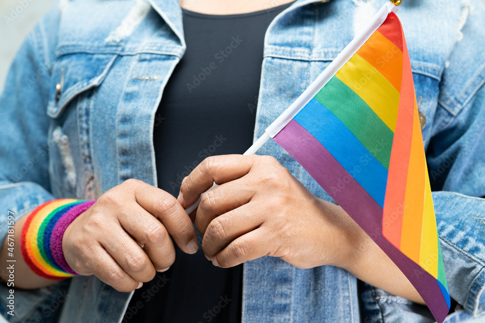 Asian lady wearing blue jean jacket or denim shirt and holding rainbow ...