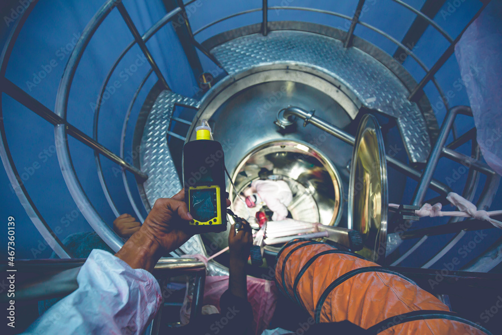 Worker hand holding gas detector inspection safety gas testing at front ...