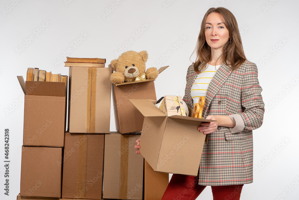 Woman home mover. Girl next to cardboard boxes. Woman Just moved in ...