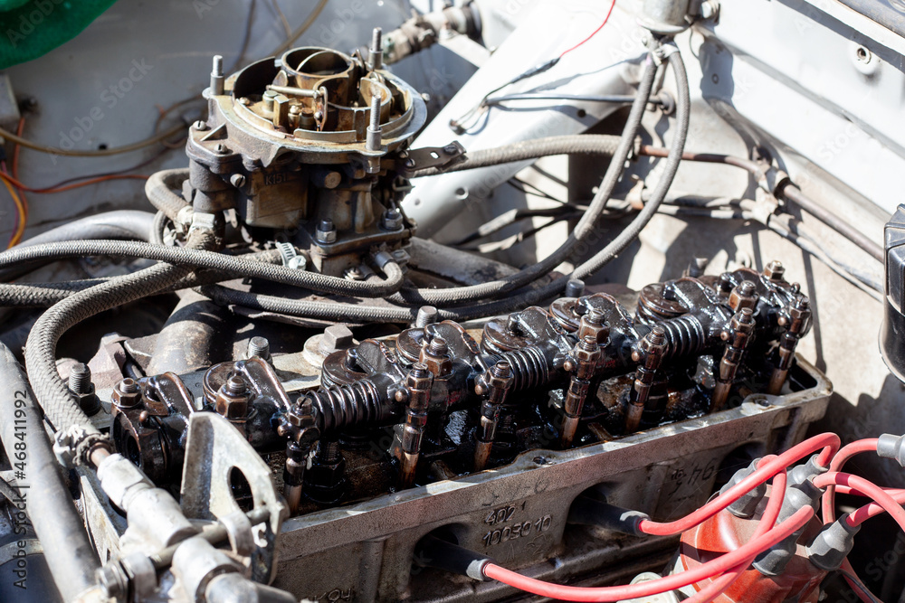Disassembled carburetor motor. Cylinder head with rocker shaft ...