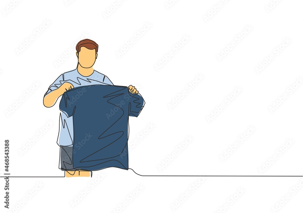 One continuous line drawing of young rising football star holding his ...