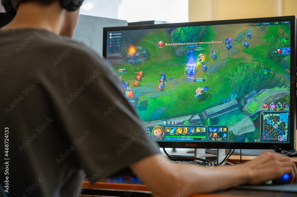Focus on Hands, Keyboards and Mouse. Back view of young gamer playing ...