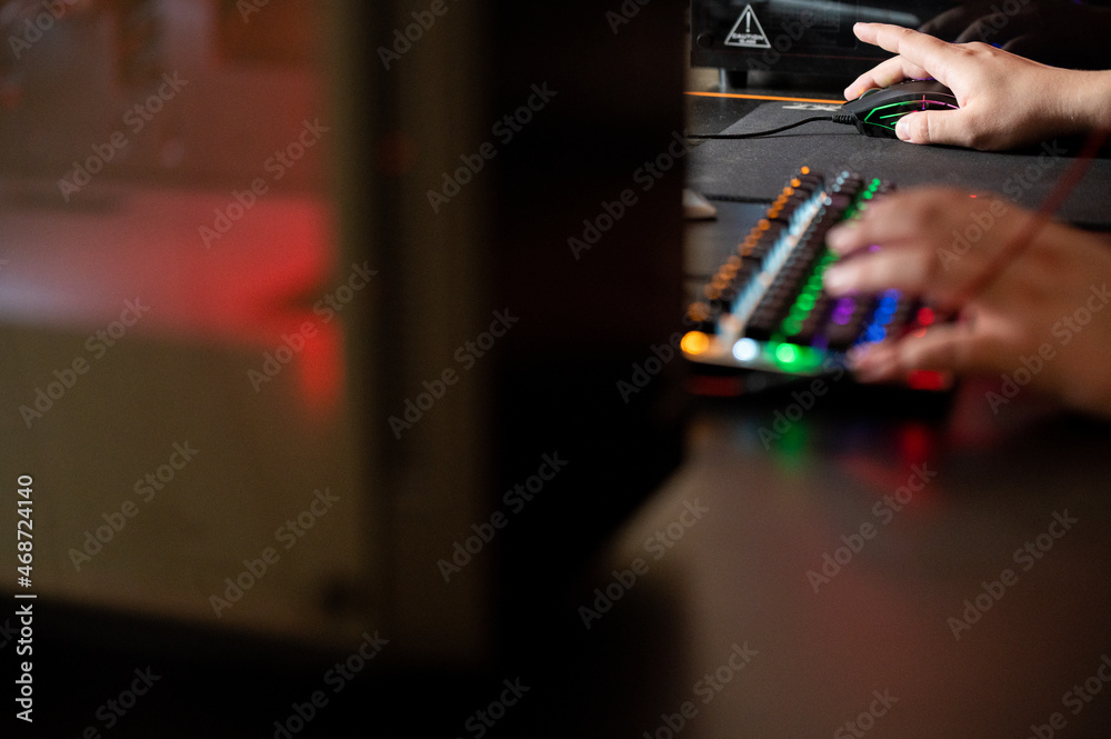 Focus on Hands, Keyboards and Mouse. Back view of young gamer playing ...