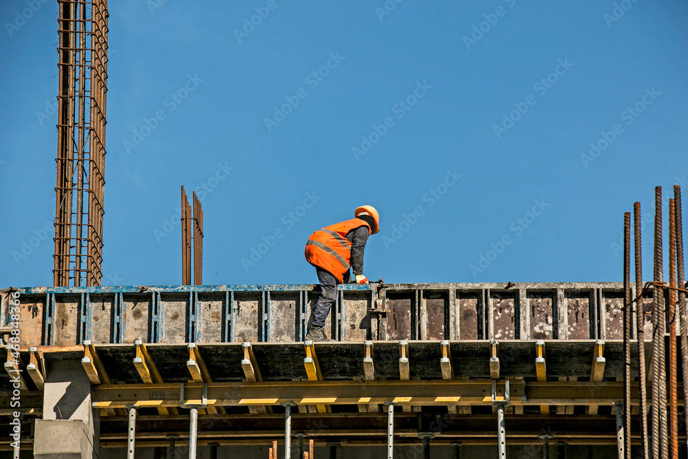 Builder installs formwork and iron reinforcement or reinforcing bar for ...