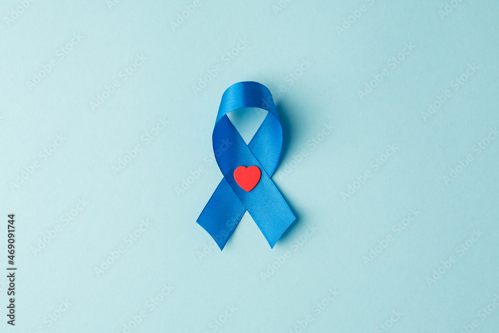 Top view photo of blue ribbon and small red heart symbol of prostate ...