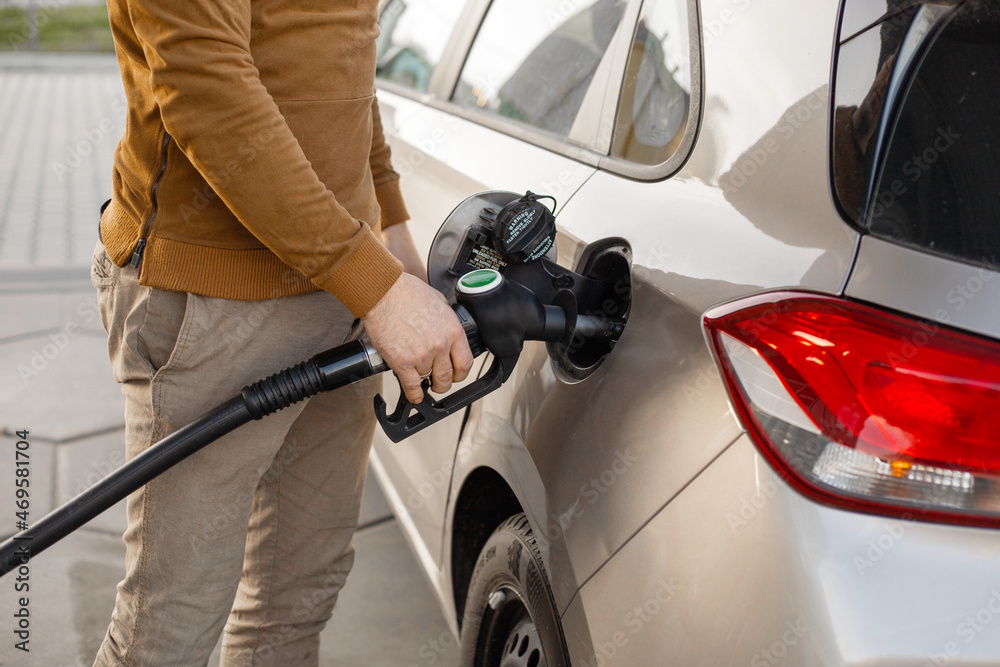 Car refueling on the petrol station. Man refilling the car with fuel ...