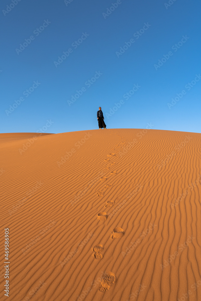 person in the sand dunes. Shaqraa, Saudi Arabia Stock Photo | Adobe Stock