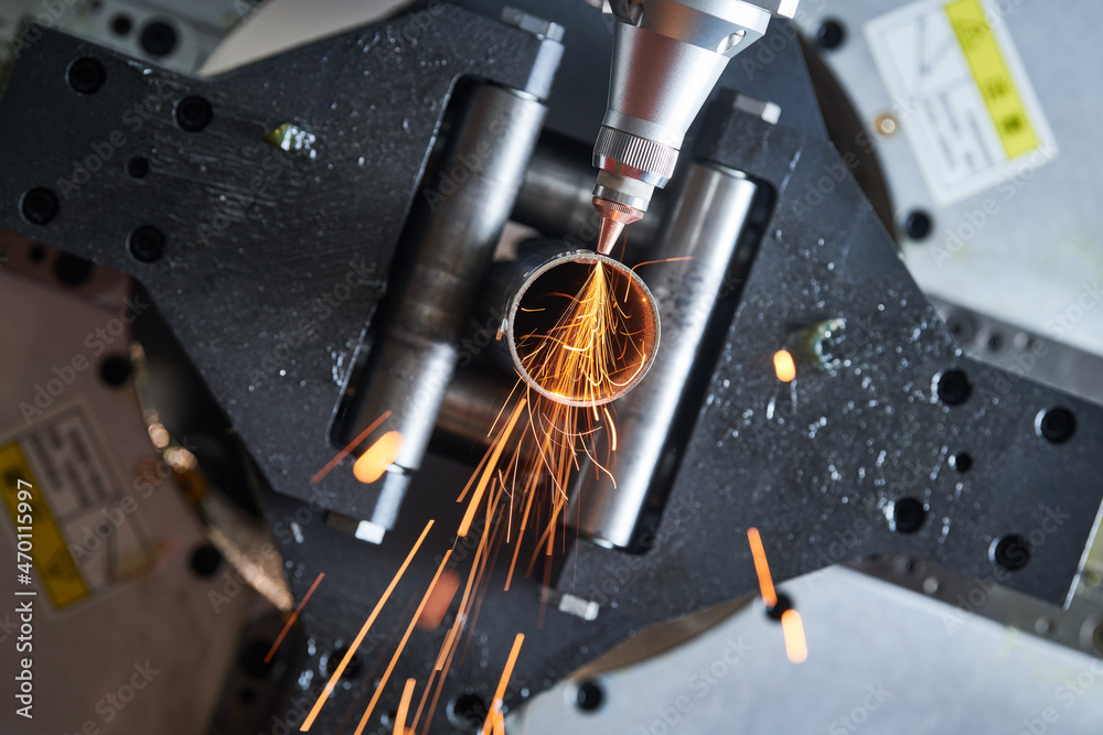 Fiber laser tube cutting machine. metal pipe cutting with sparks Stock ...
