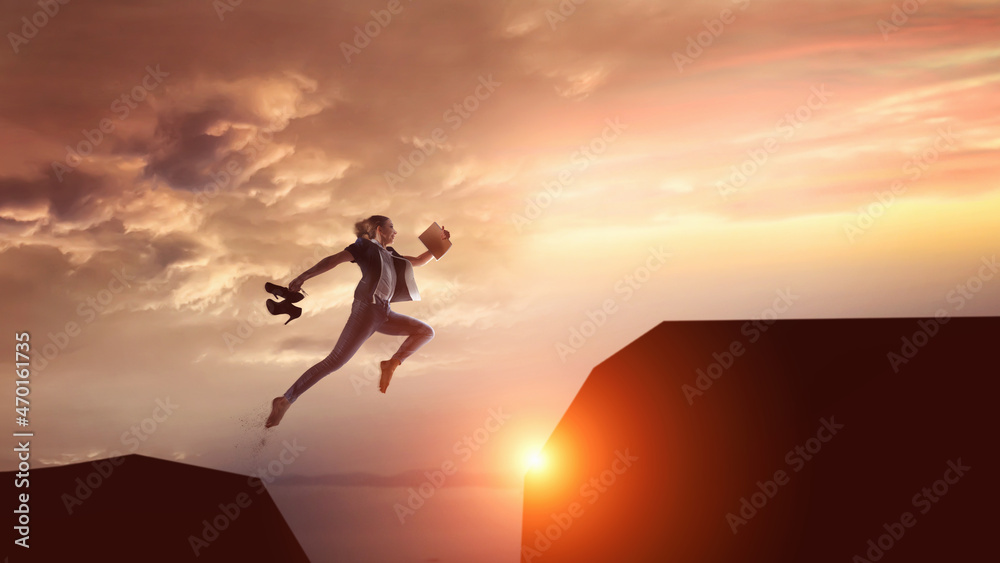 Silhouette woman jumping between cliff with number 2021 to 2022 and ...
