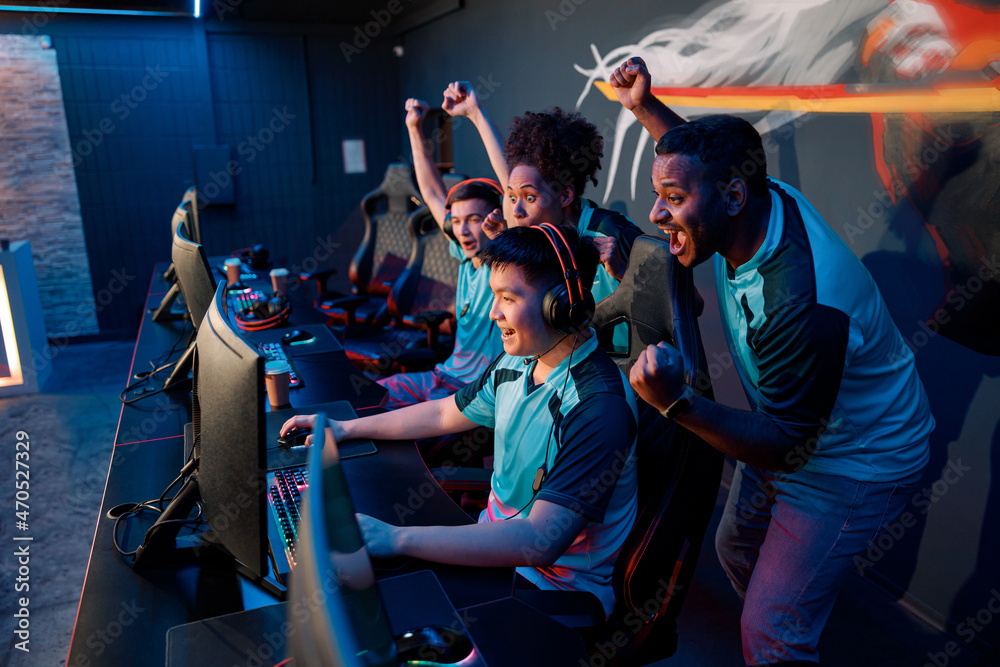 Multiracial team of happy professional cyber sports gamers celebrating ...